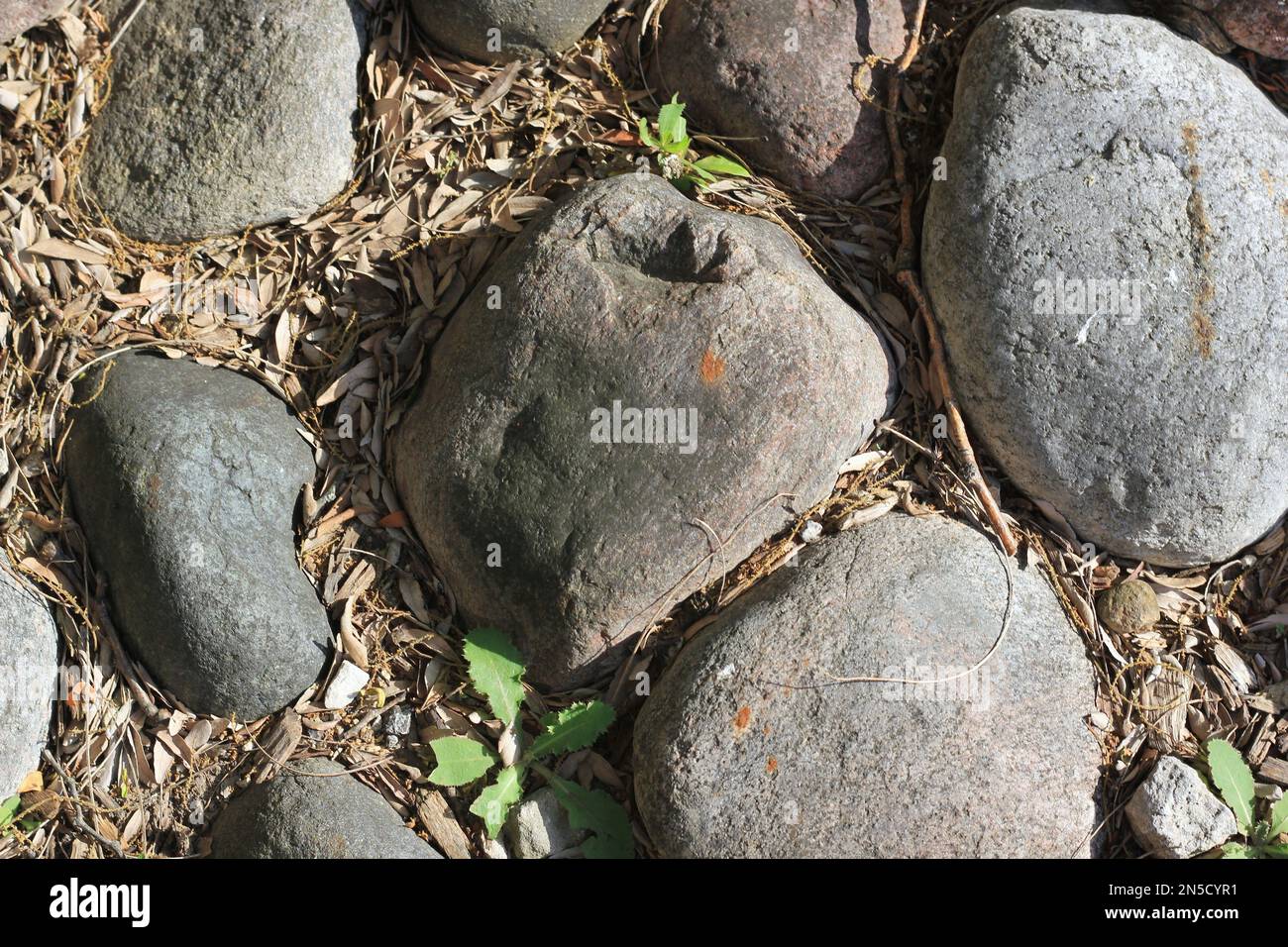 Rocks and stones piled high in the rock garden Stock Photo - Alamy