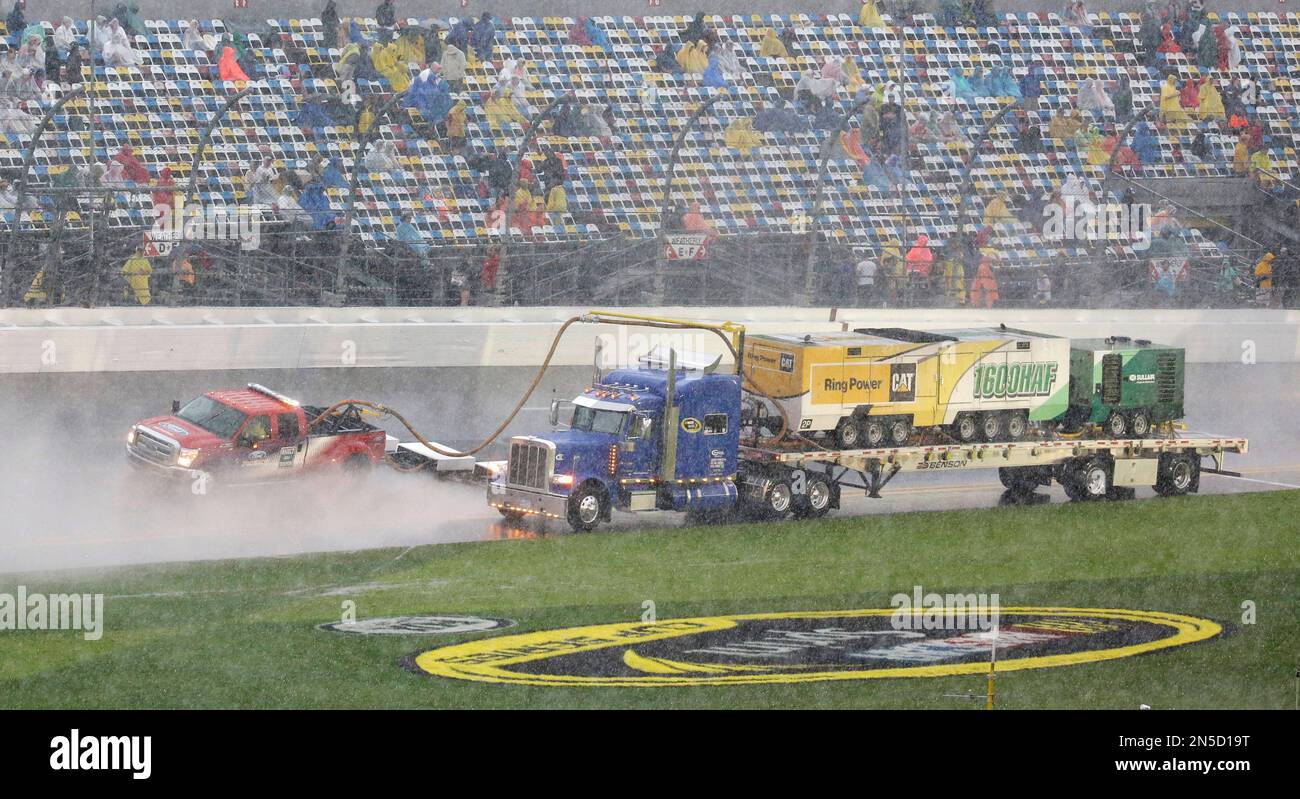 Track dryers go along the front stretch during a rain delay in the ...