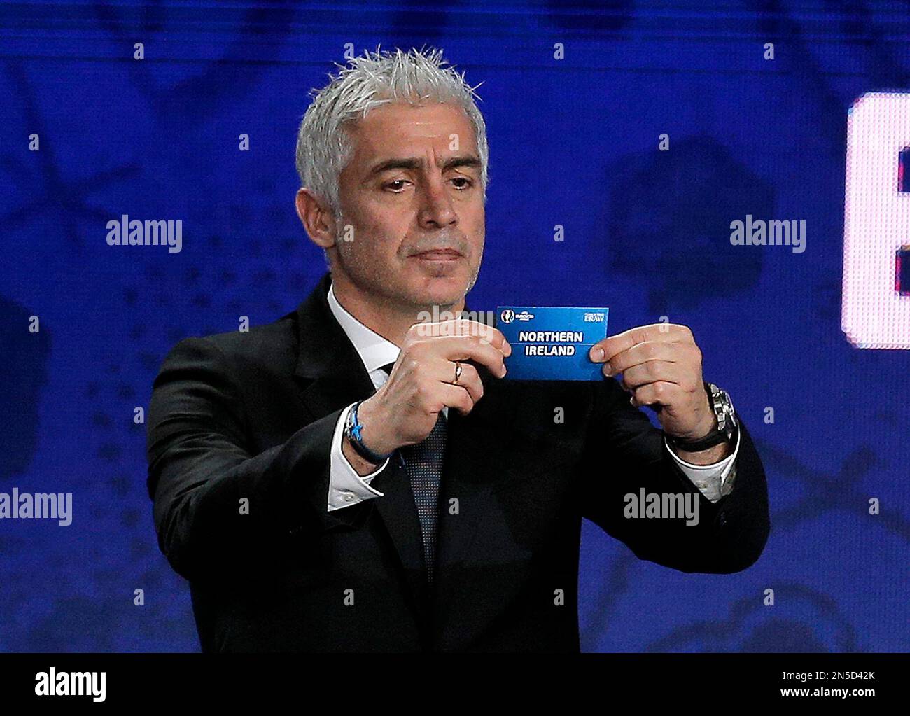 Greek former soccer player Antonios Nikopolidis shows the draw of ...