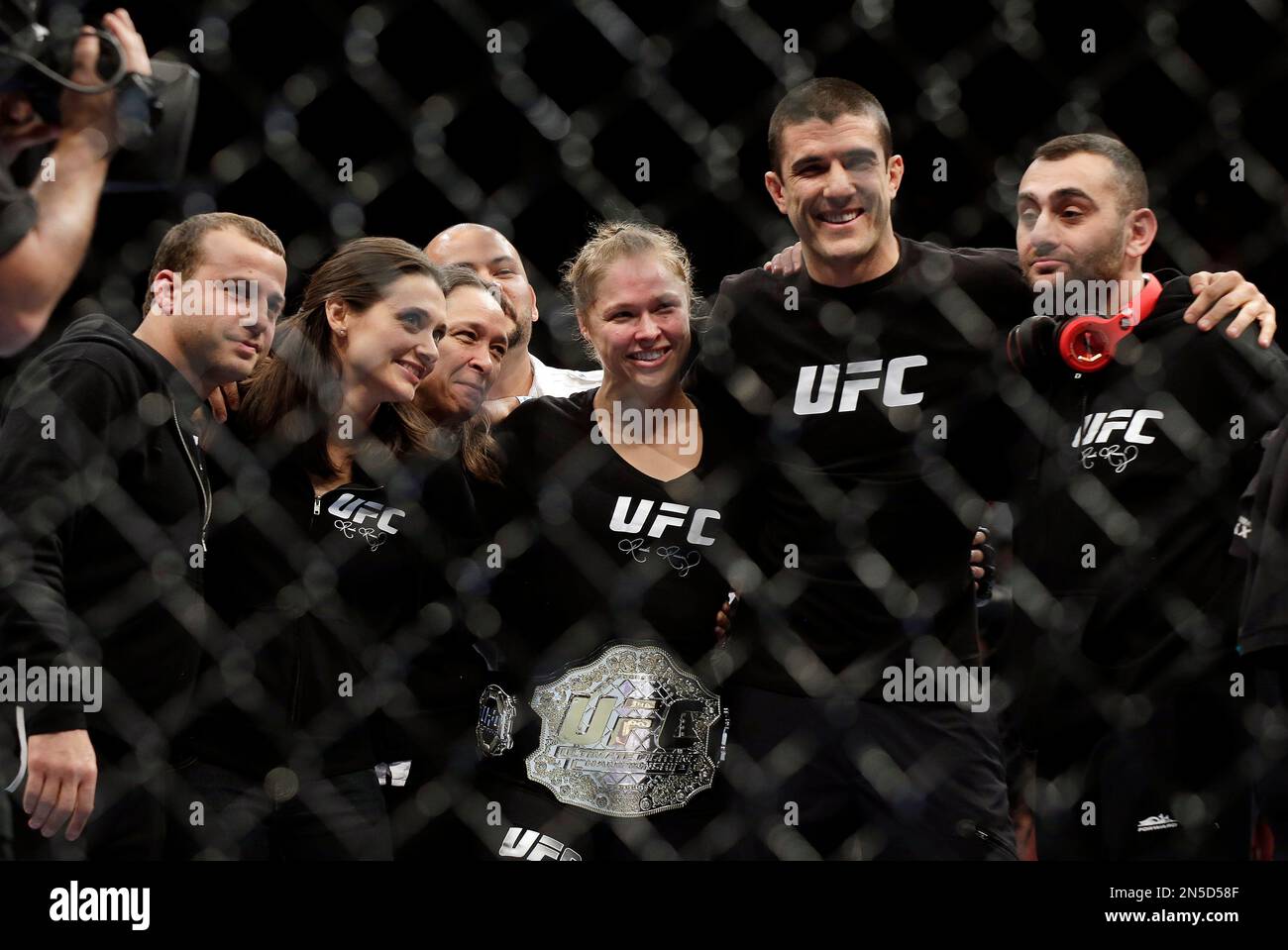 Ronda Rousey, center, poses with her team following a UFC 170 mixed ...