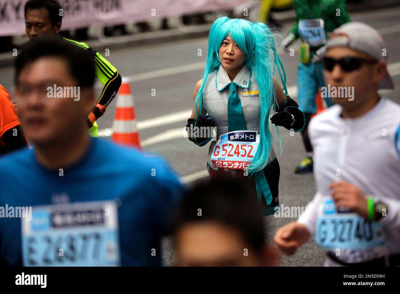 A runner wearing an anime costume races with others during the Tokyo ...