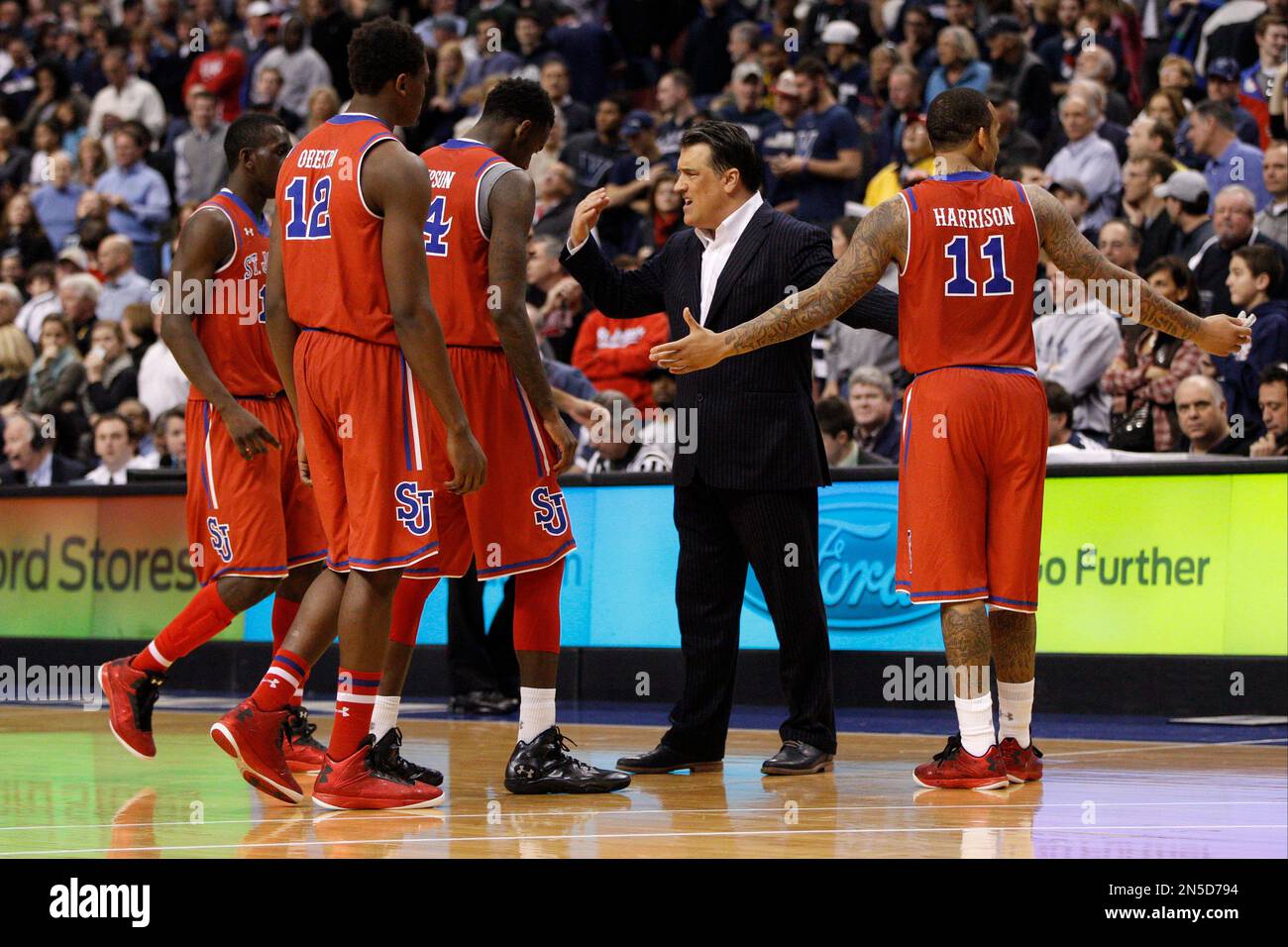 St. John's head coach Steve Lavin, center, huddles up his team during ...