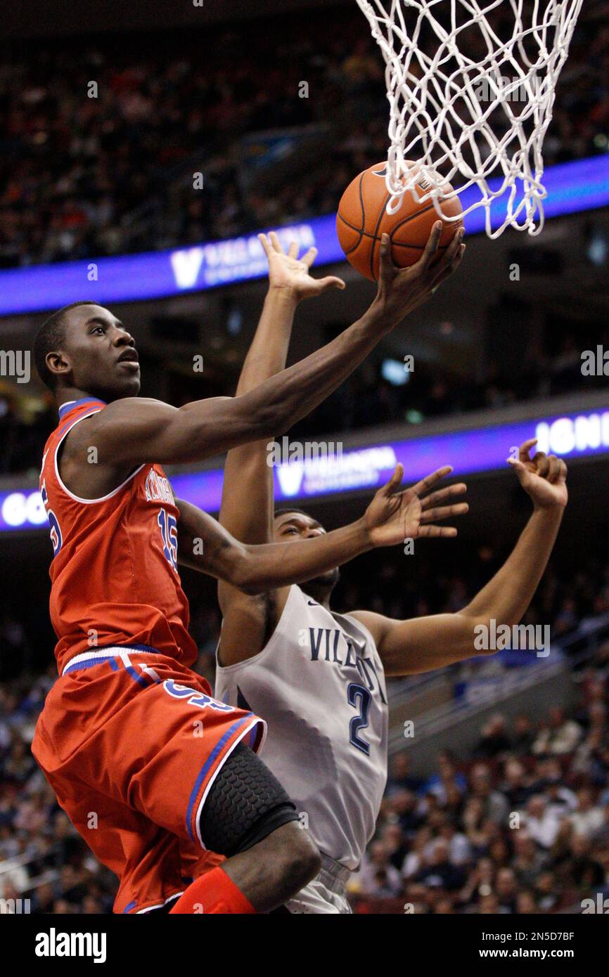 St. John's Sir'Dominic Pointer, left, goes up for the shot over ...