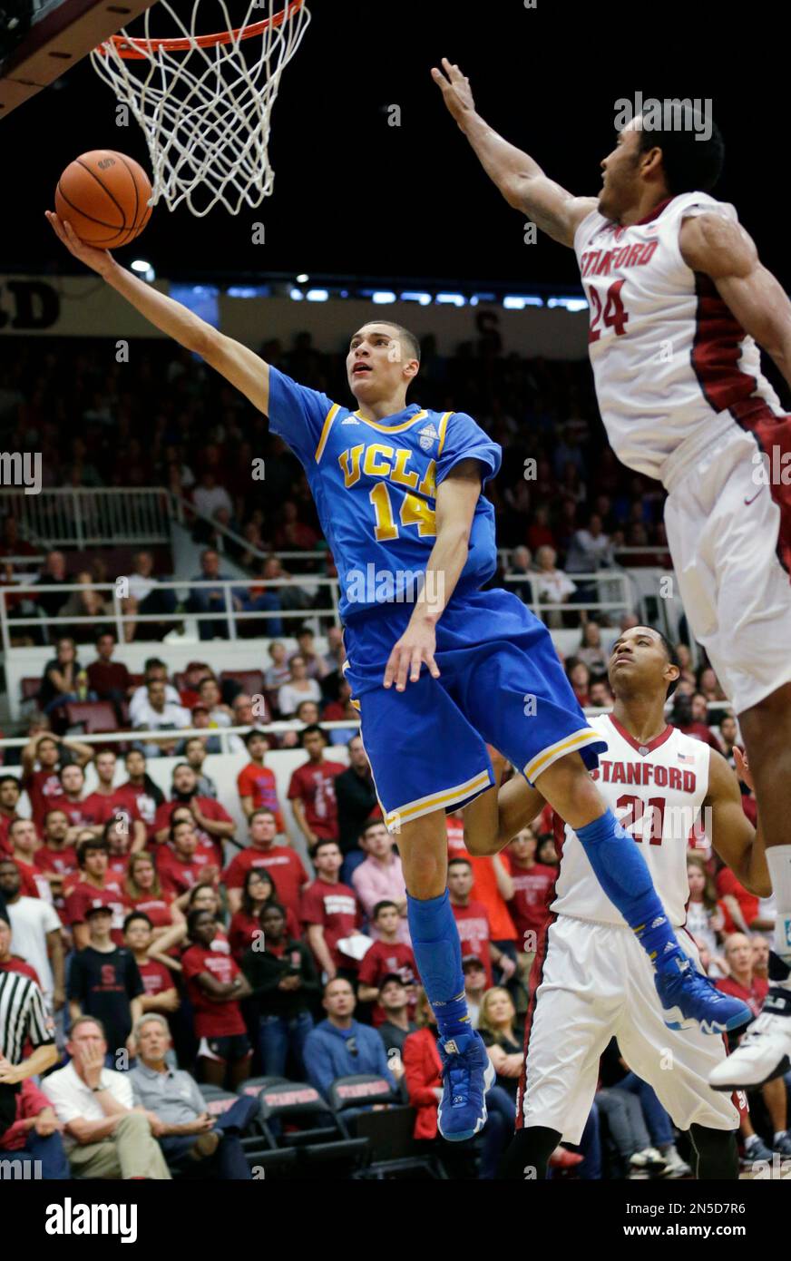 UCLA guard Zach LaVine (14) scores on a layup next to Stanford forward ...
