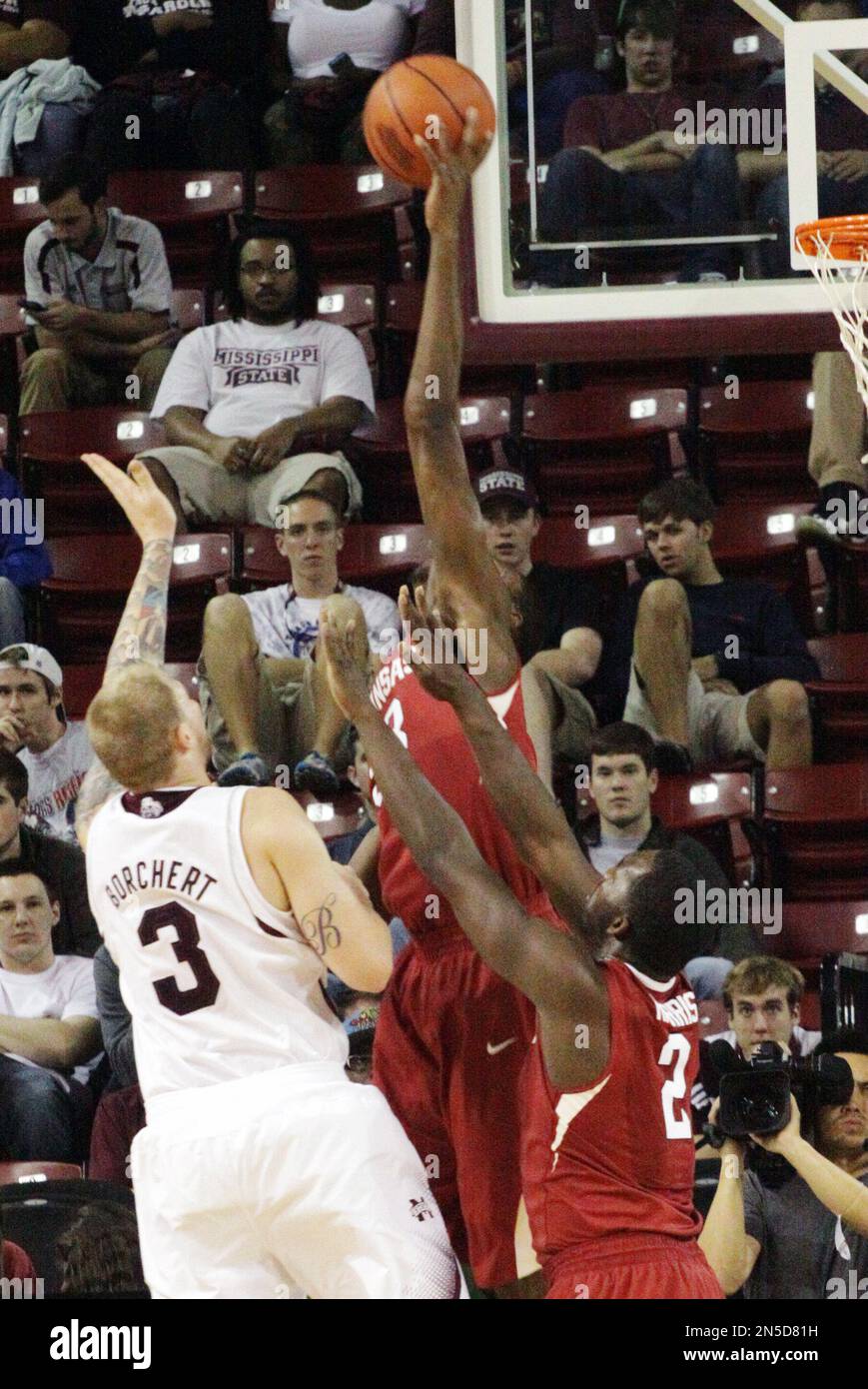 Arkansas' Moses Kingsley, center, blocks a shot by Mississippi State's ...