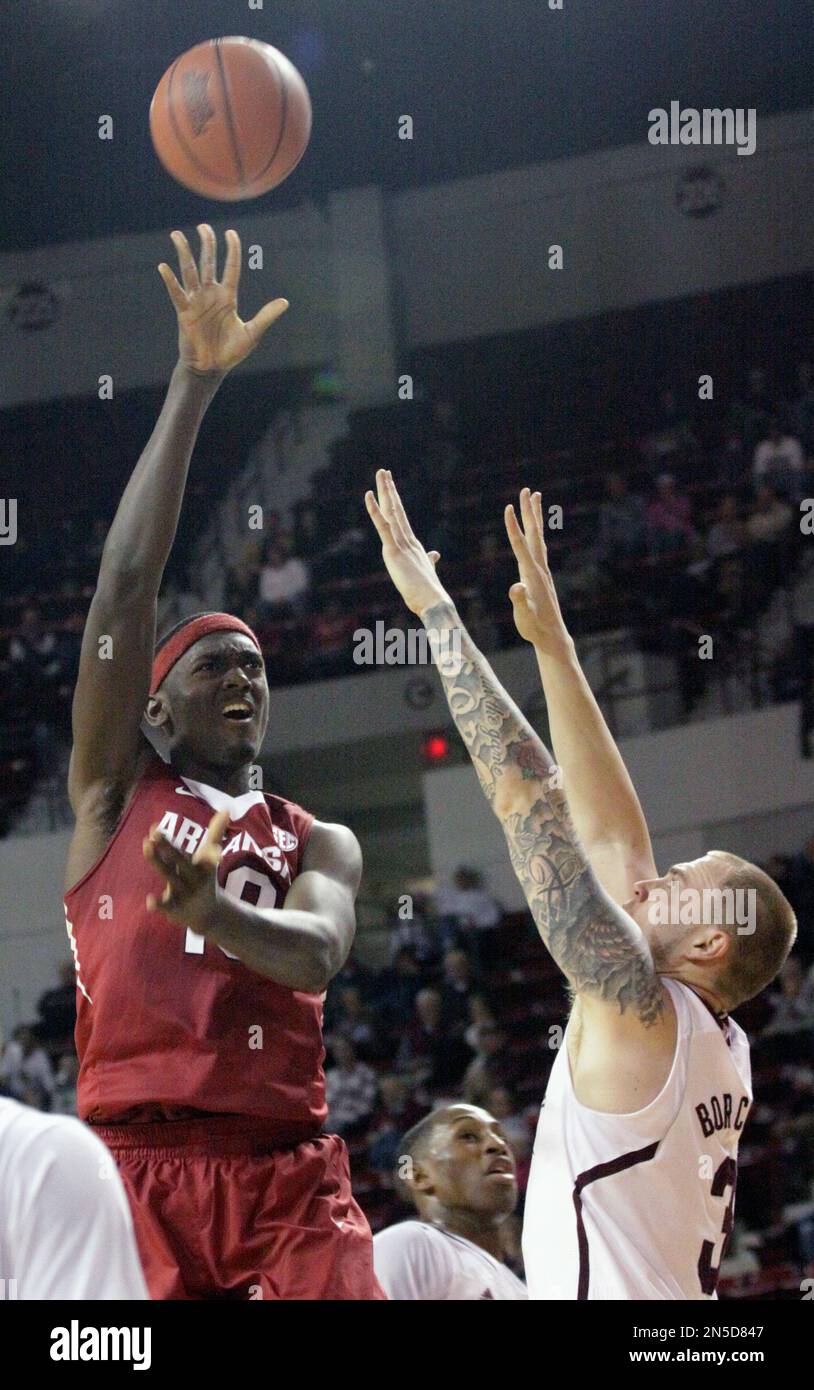 Arkansas' Bobby Portis, left, shoots over Mississippi State's Colin ...