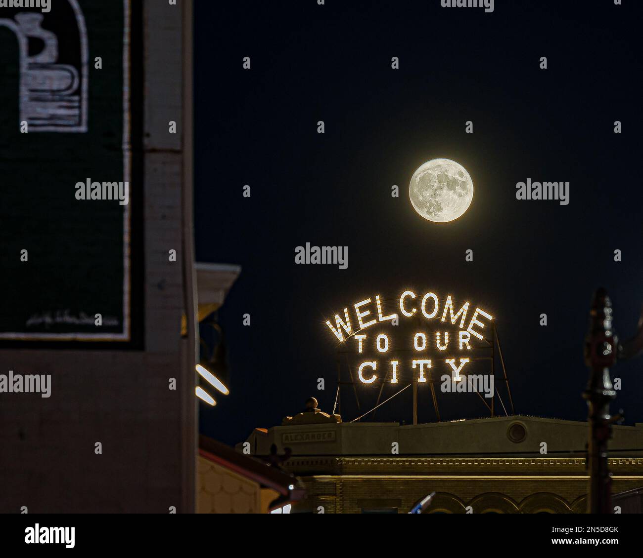 The Full moon rising over New Philadelphia's welcome sign in the USA ...