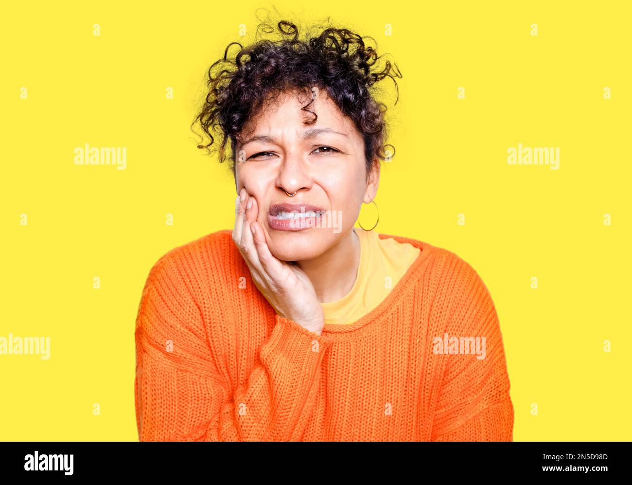 Black woman suffering toothache face portrait over yellow background ...