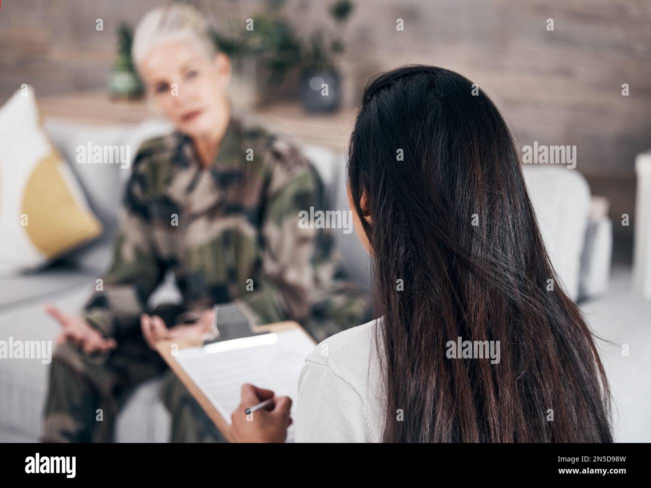 Soldier, psychologist and conversation on sofa for mental health ...