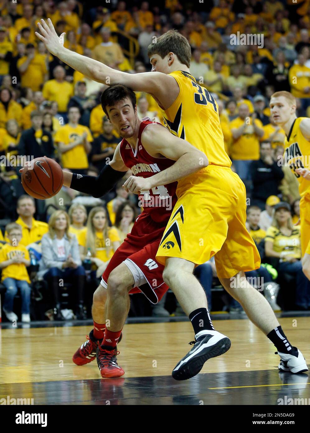Wisconsin forward Frank Kaminsky tries to go around Iowa center Adam ...