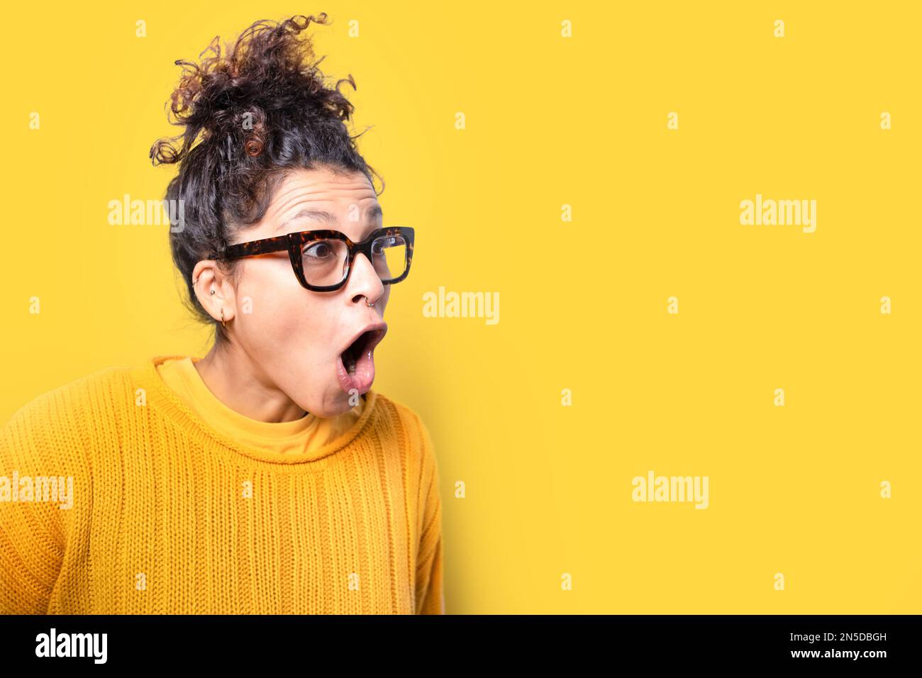 Surprised shocked black woman face expression on yellow background ...