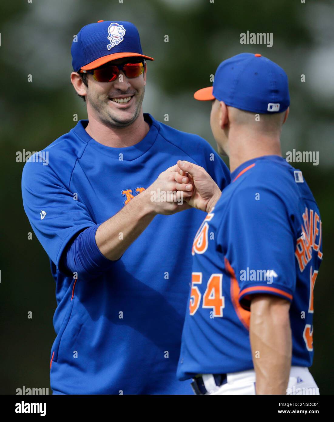 New York Mets pitcher Matt Harvey gets a fist bump from bullpen catcher ...