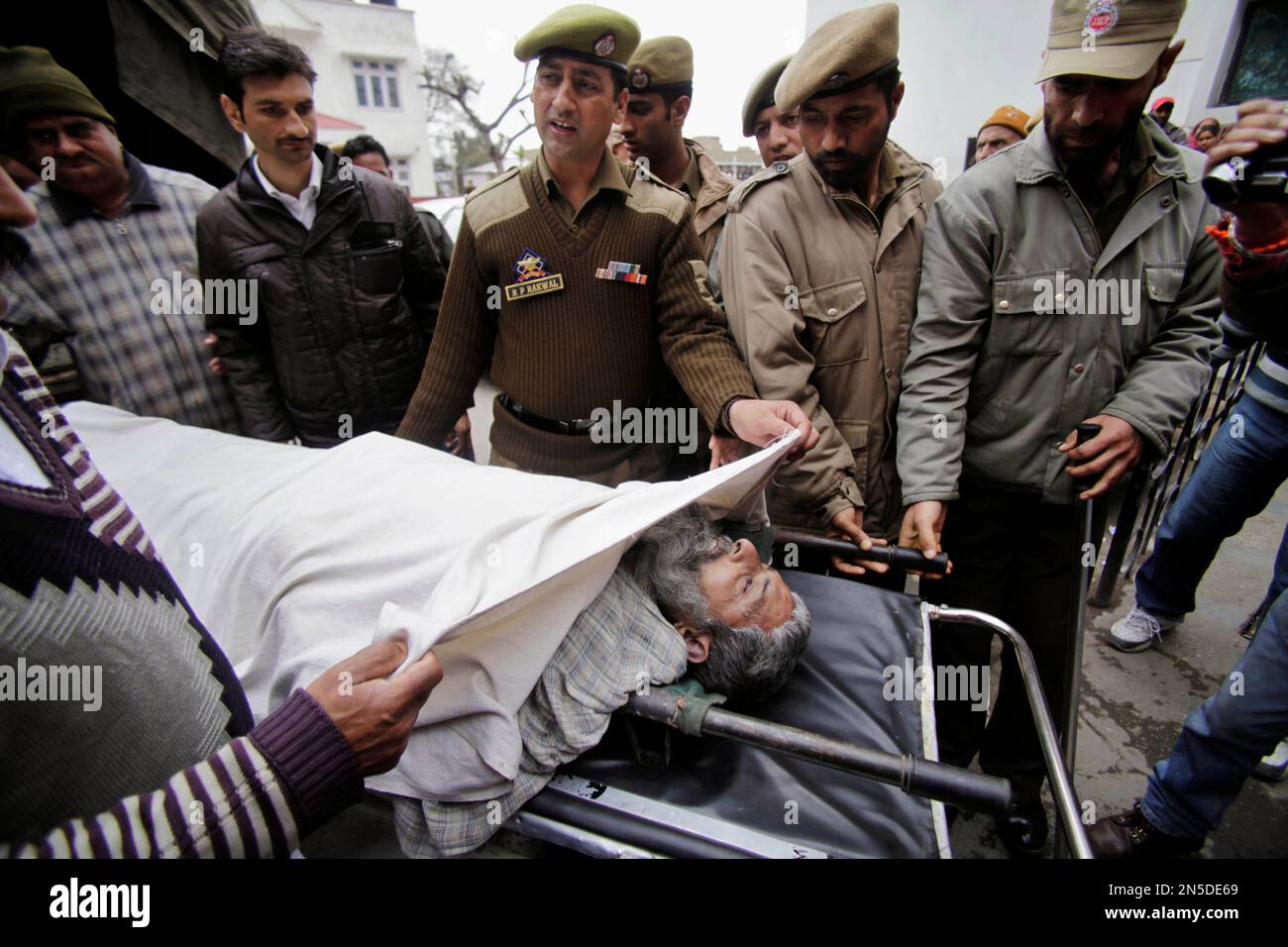 Pakistani prisoner Showkat Ali is carried on a stretcher to be shifted ...