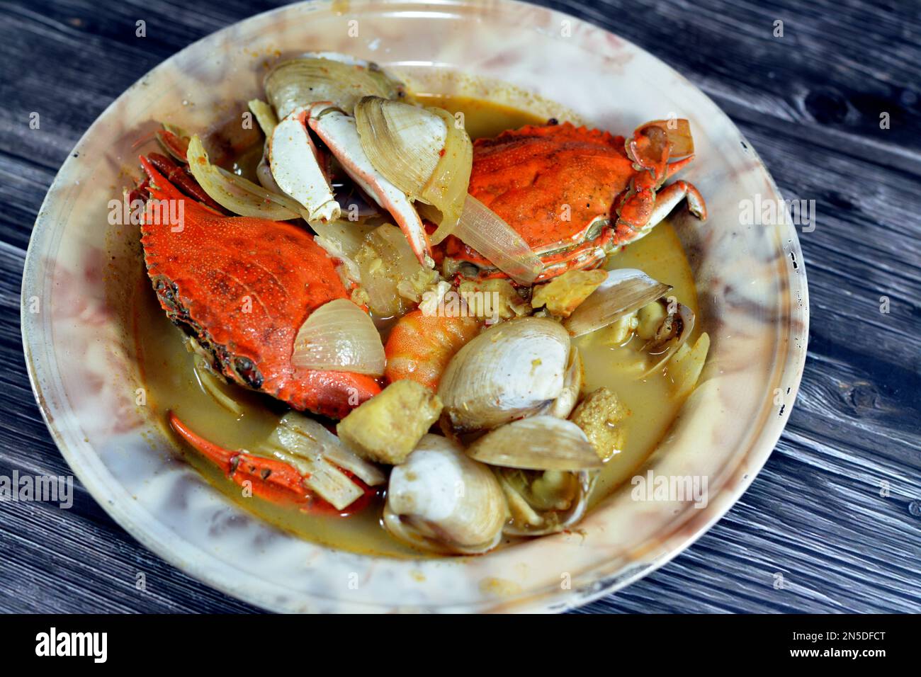 Hot soup meal of various fresh seafood marine crabs, shrimps, clams, mussels, gandofli, oysters ...