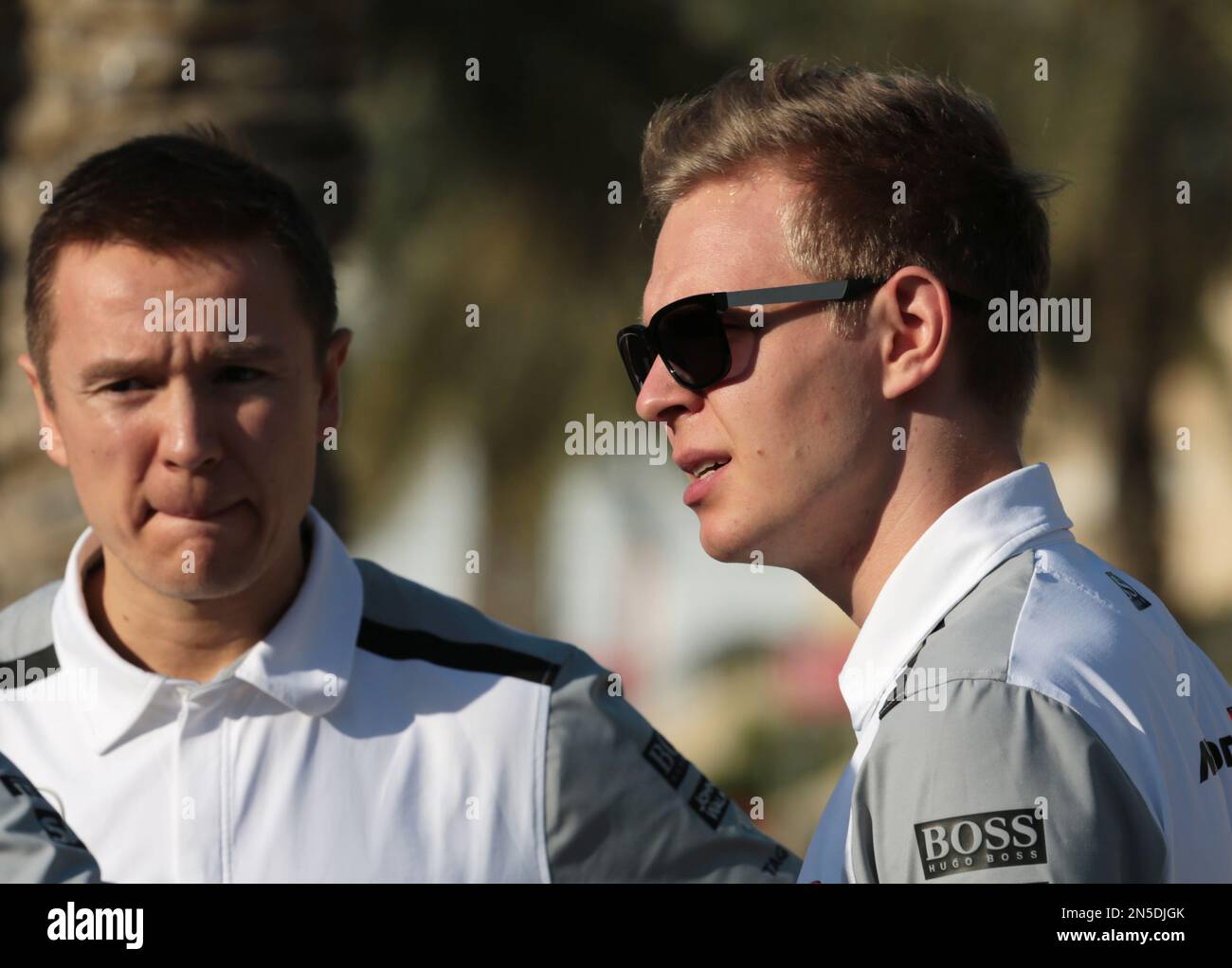 Formula One driver Kevin Magnussen of McLaren, right, talks with a ...