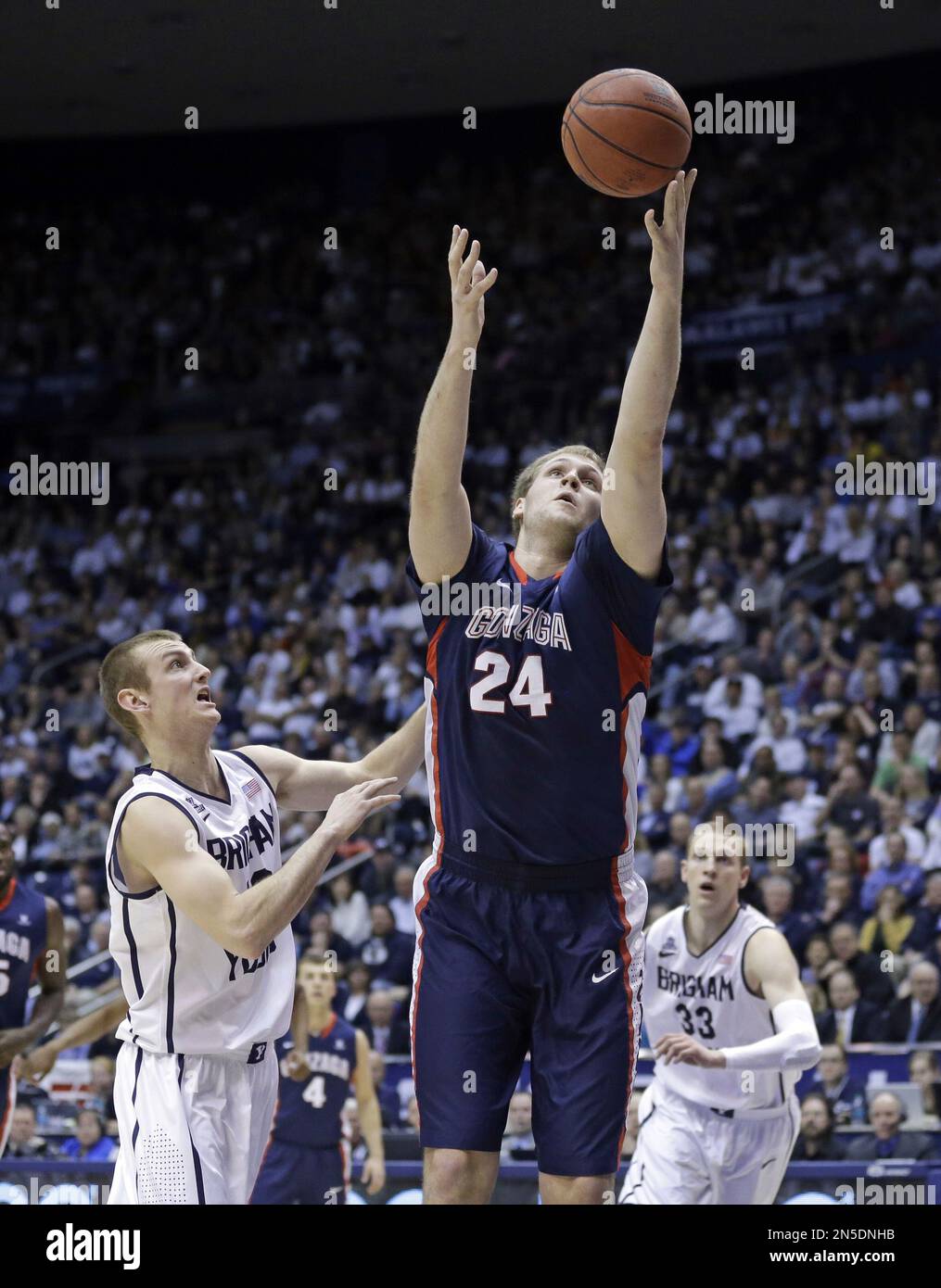 Brigham Young's Josh Sharp, left, looks on as Gonzaga's Przemek ...