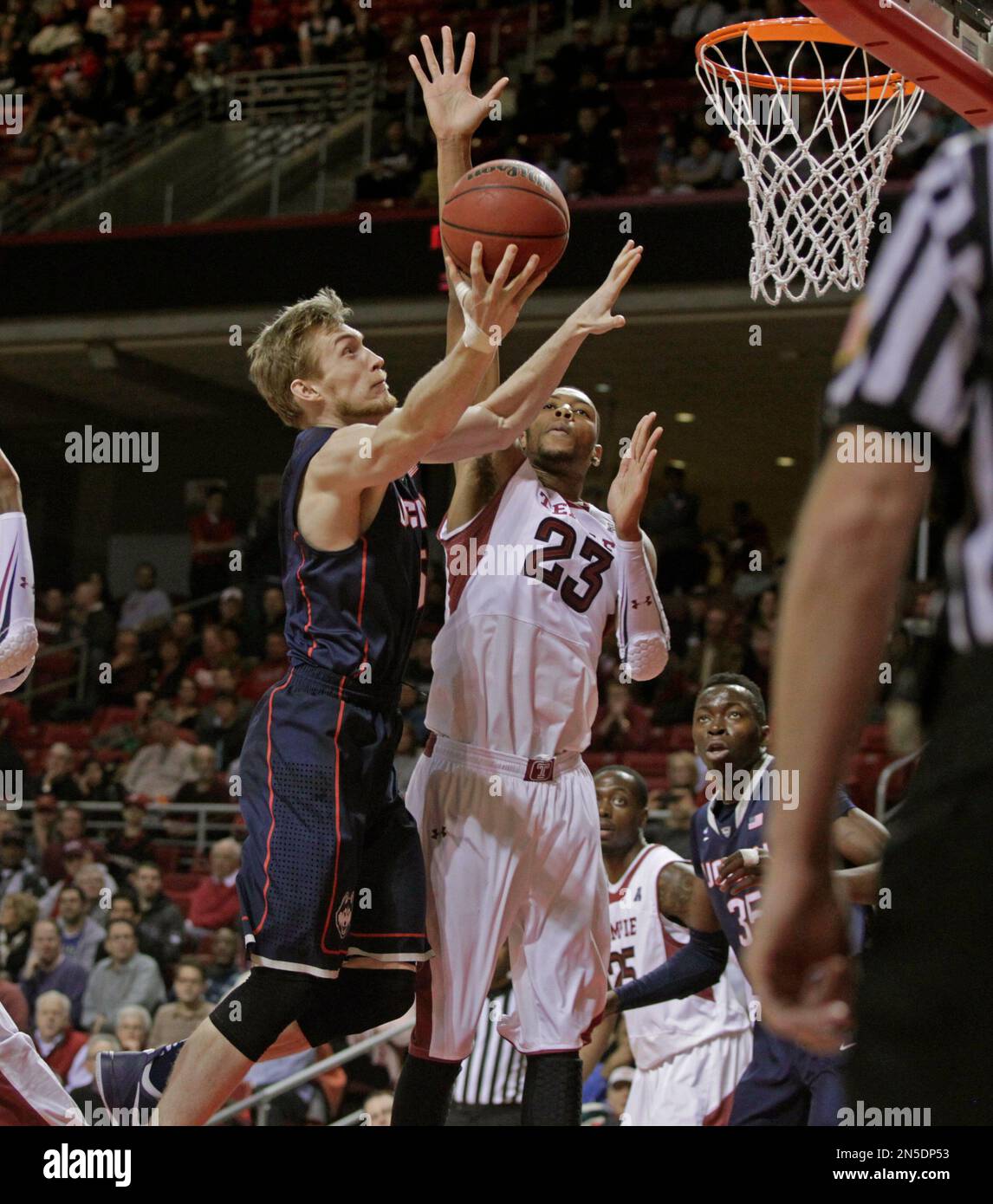 Connecticut's Niels Giffey, left shoots as Temple's Devontae Watson (23 ...