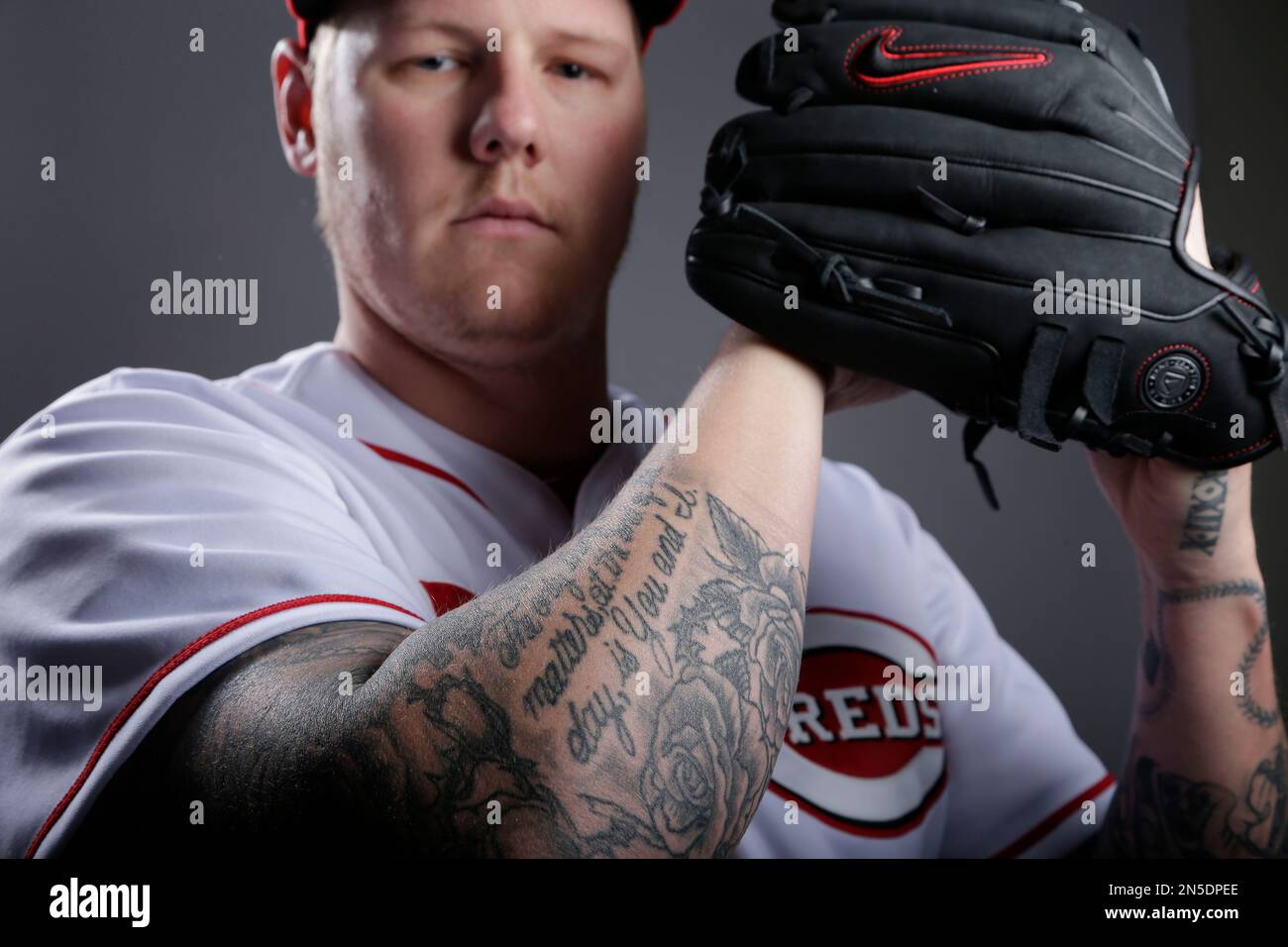 Cincinnati Reds pitcher Mat Latos shows his tattoos as he poses for a ...