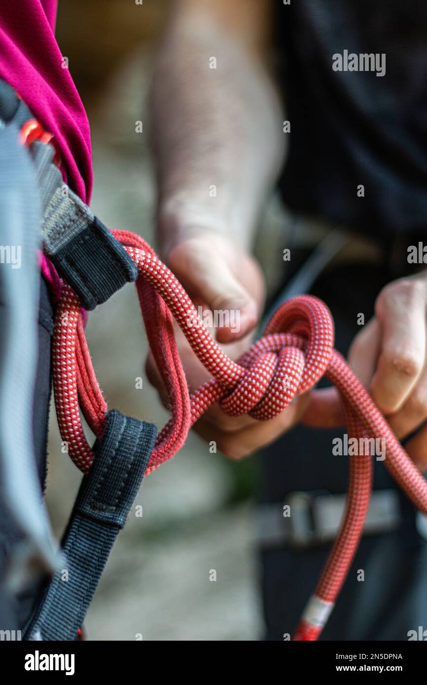 Alpinist tying rope on hi-res stock photography and images - Alamy