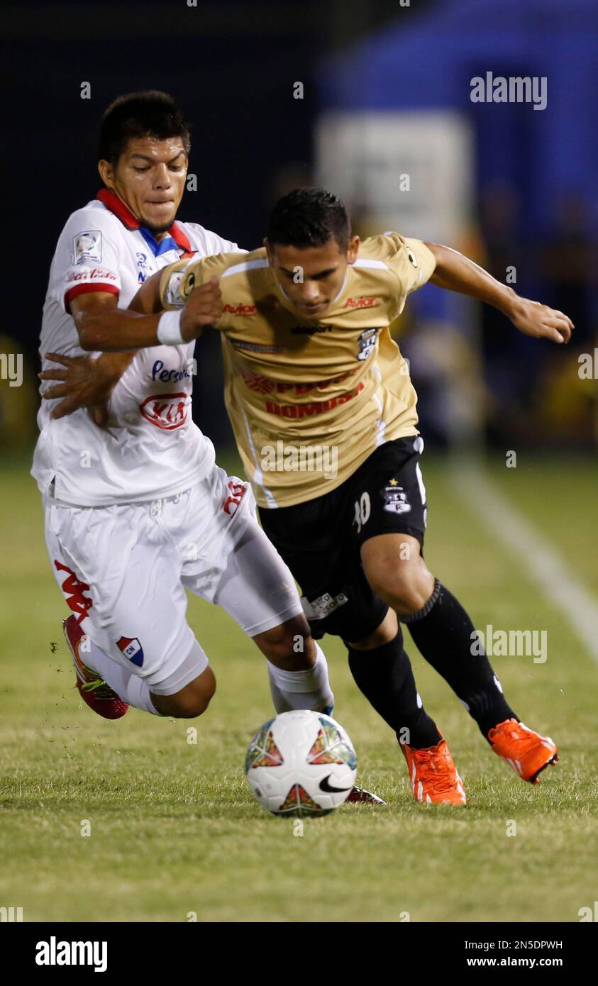 Marcos Riveros of Paraguay's Nacional, left, fights for the ball with ...