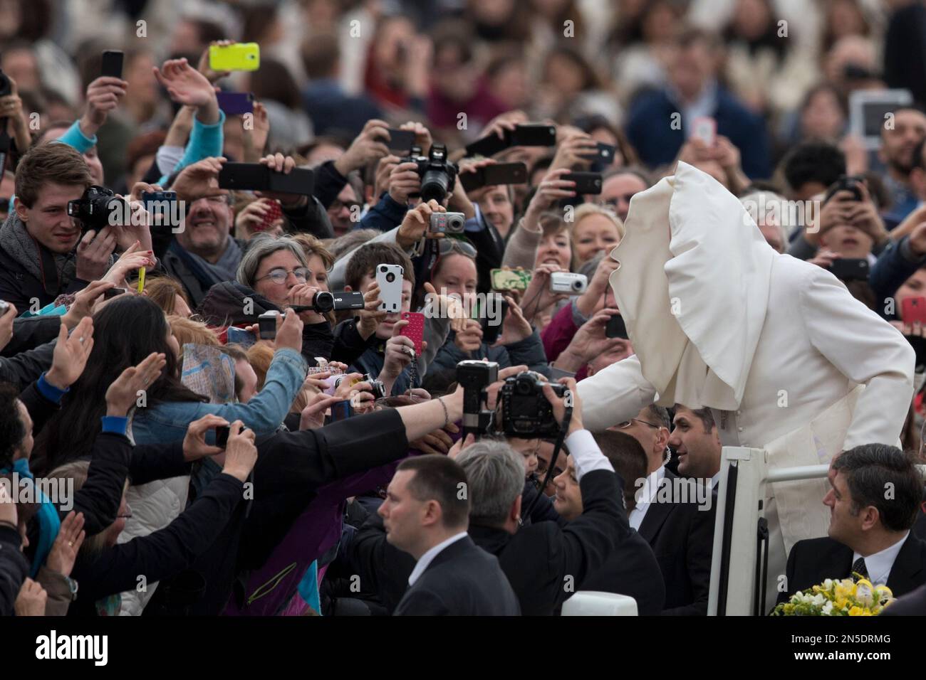 A gust of wind blows Pope Francis' cape as he arrives for his weekly ...