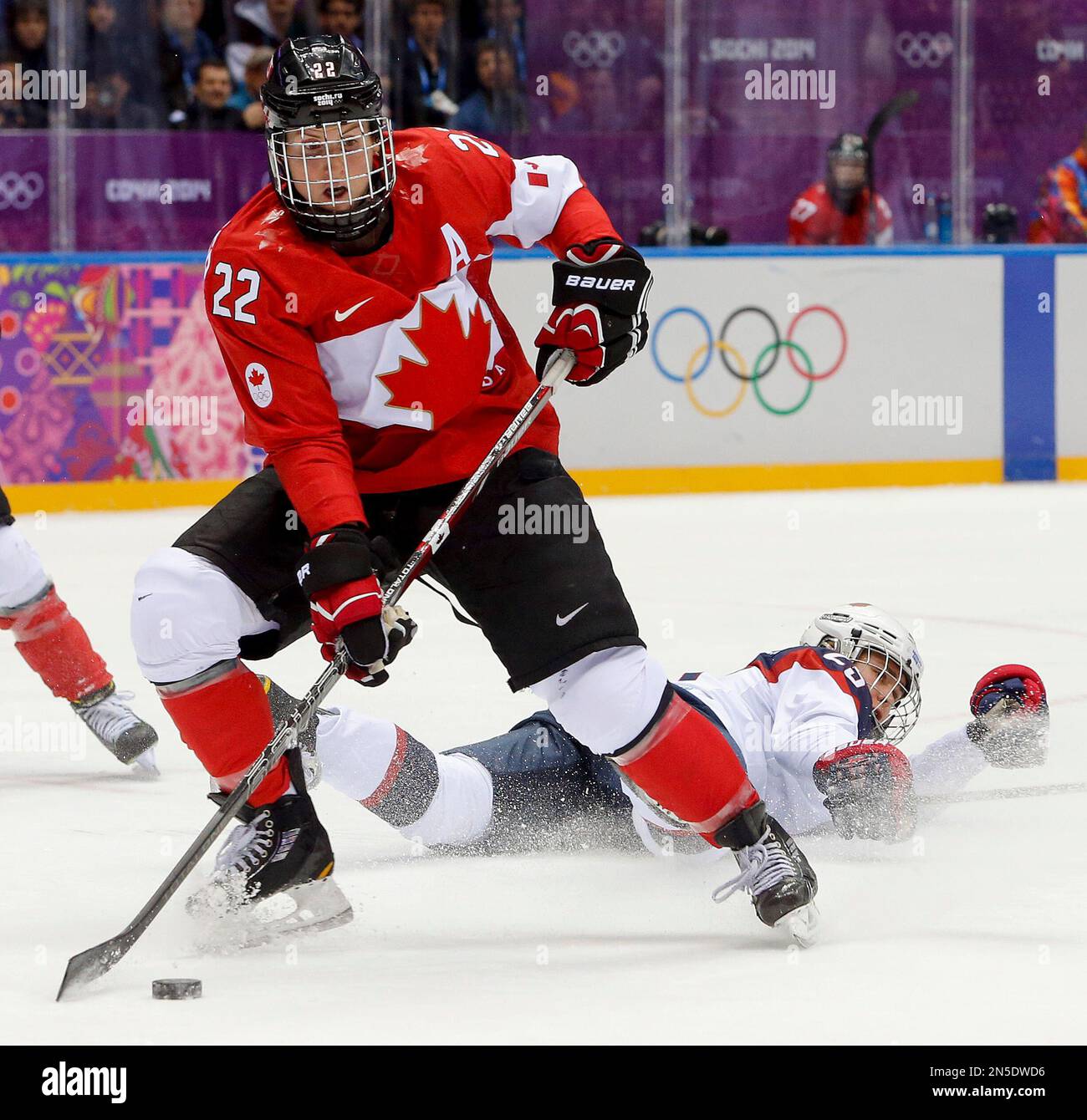 Alex Carpenter of the United States (25) hits the ice as Hayley ...