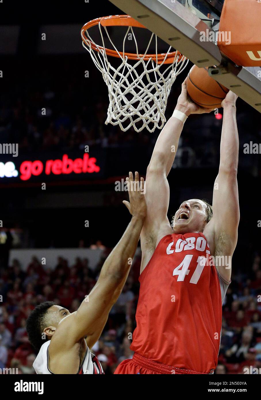 New Mexico's Cameron Bairstow, of Australia, dunks over UNLV's Khem ...