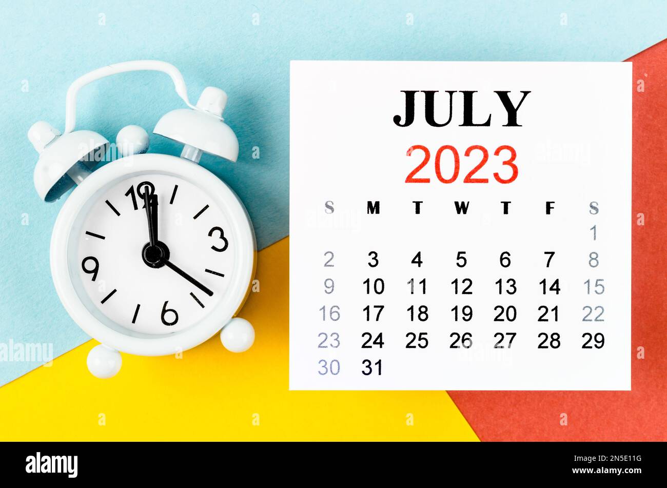 July 2023 Monthly calendar year with alarm clock on colourful ...
