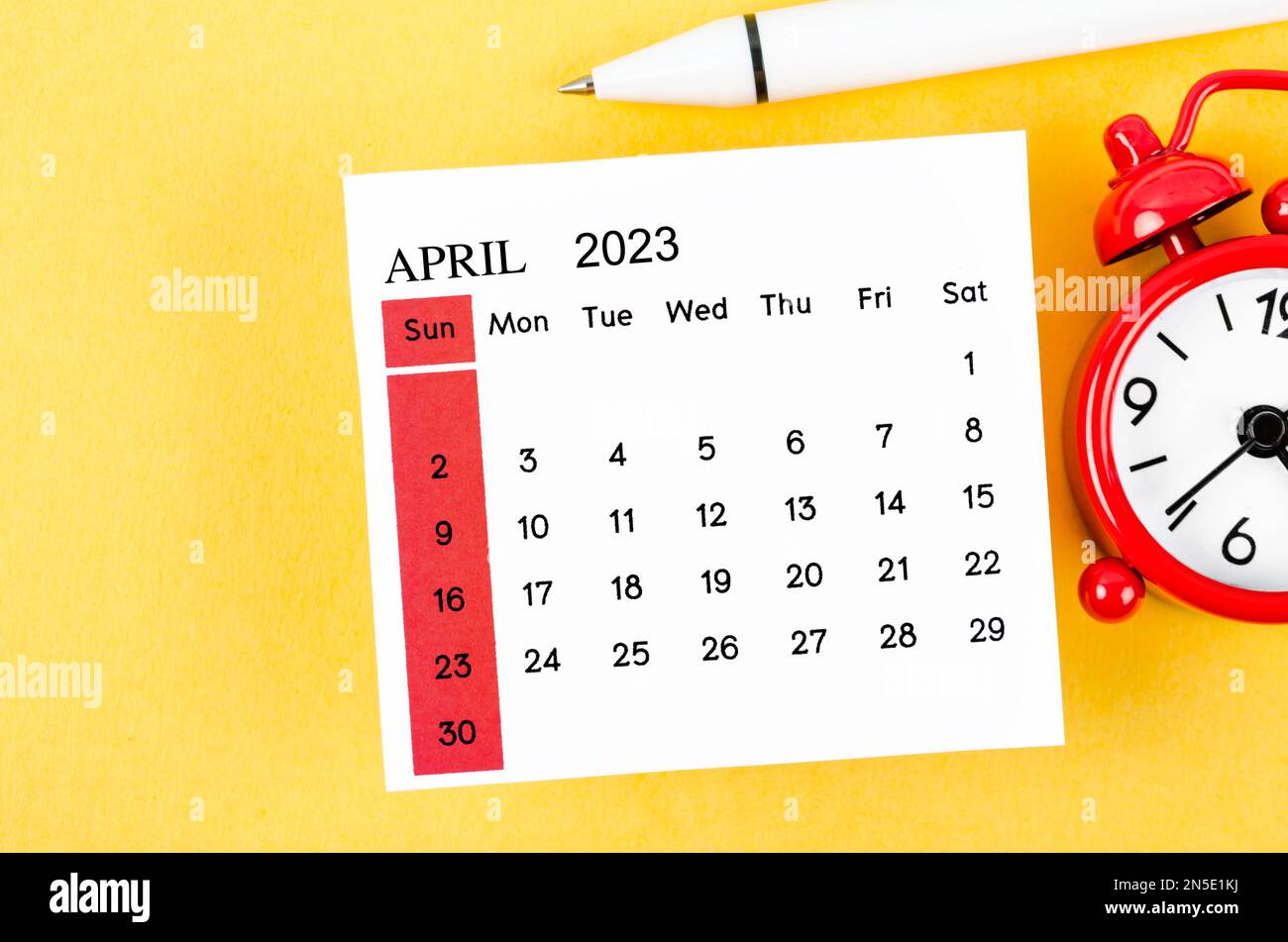 April 2023 Monthly calendar for 2023 year with alarm clock on yellow ...