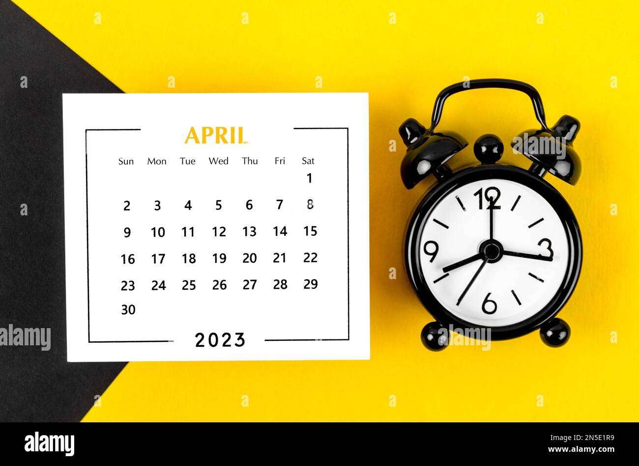 April 2023 Monthly calendar for 2023 year with black colour alarm clock ...