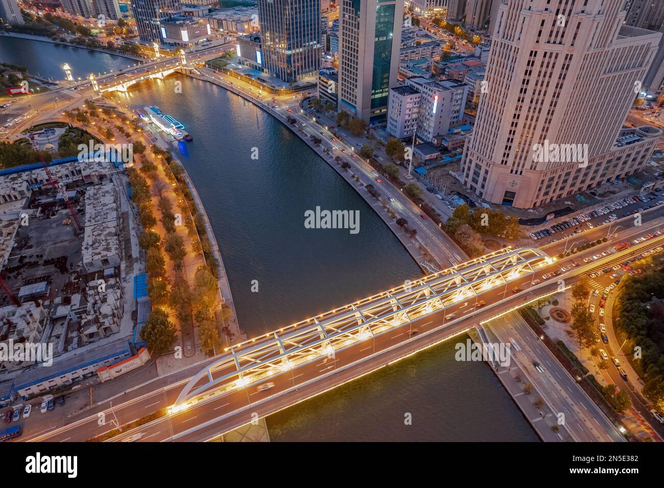 An aerial view of the Haihe River and the modern illuminated bridge in ...