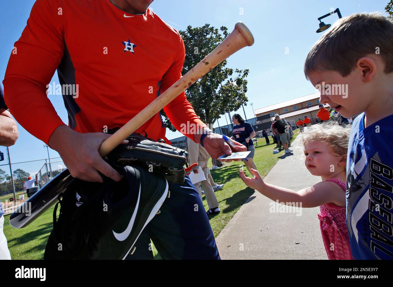 Houston Astros outfielder George Springer takes a card to sign from ...
