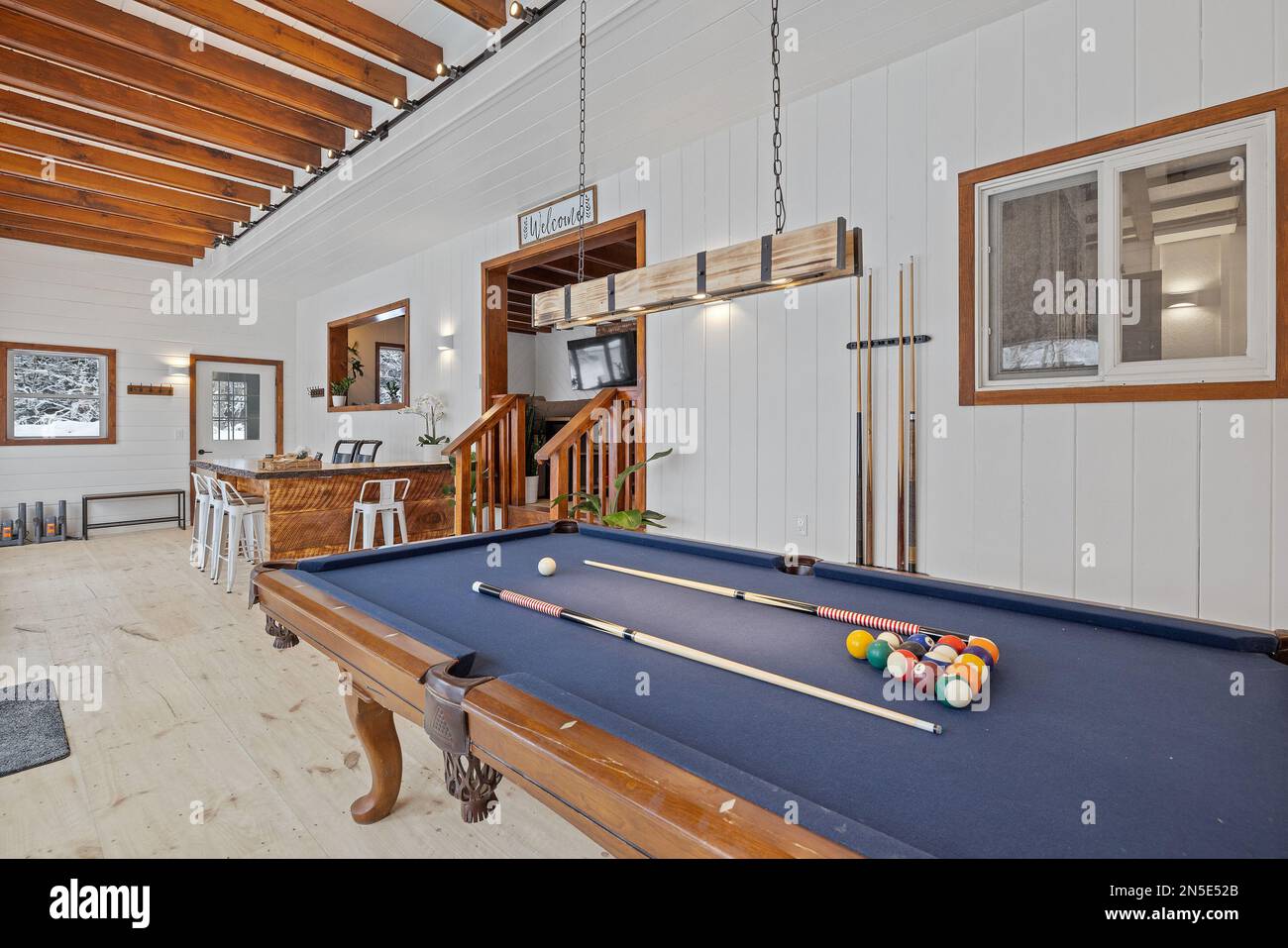 A large pool table in a room with wooden elements Stock Photo - Alamy