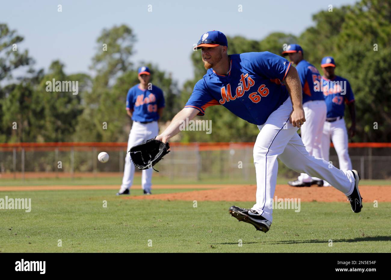New York Mets pitcher Josh Edgin flips a ball home during a drill at ...