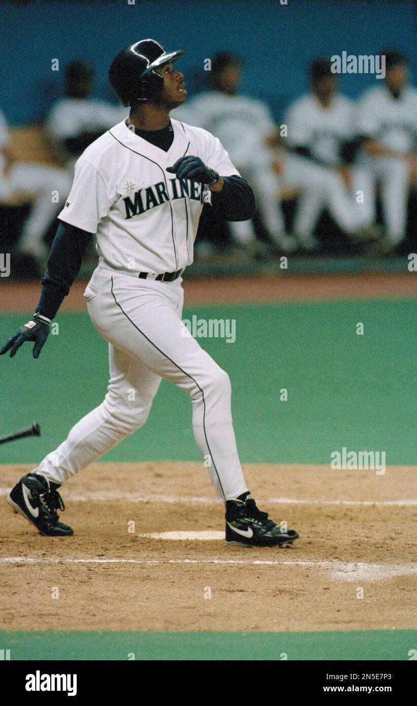 Ken Griffey Jr. of the Seattle Mariners follows through on his swing as ...