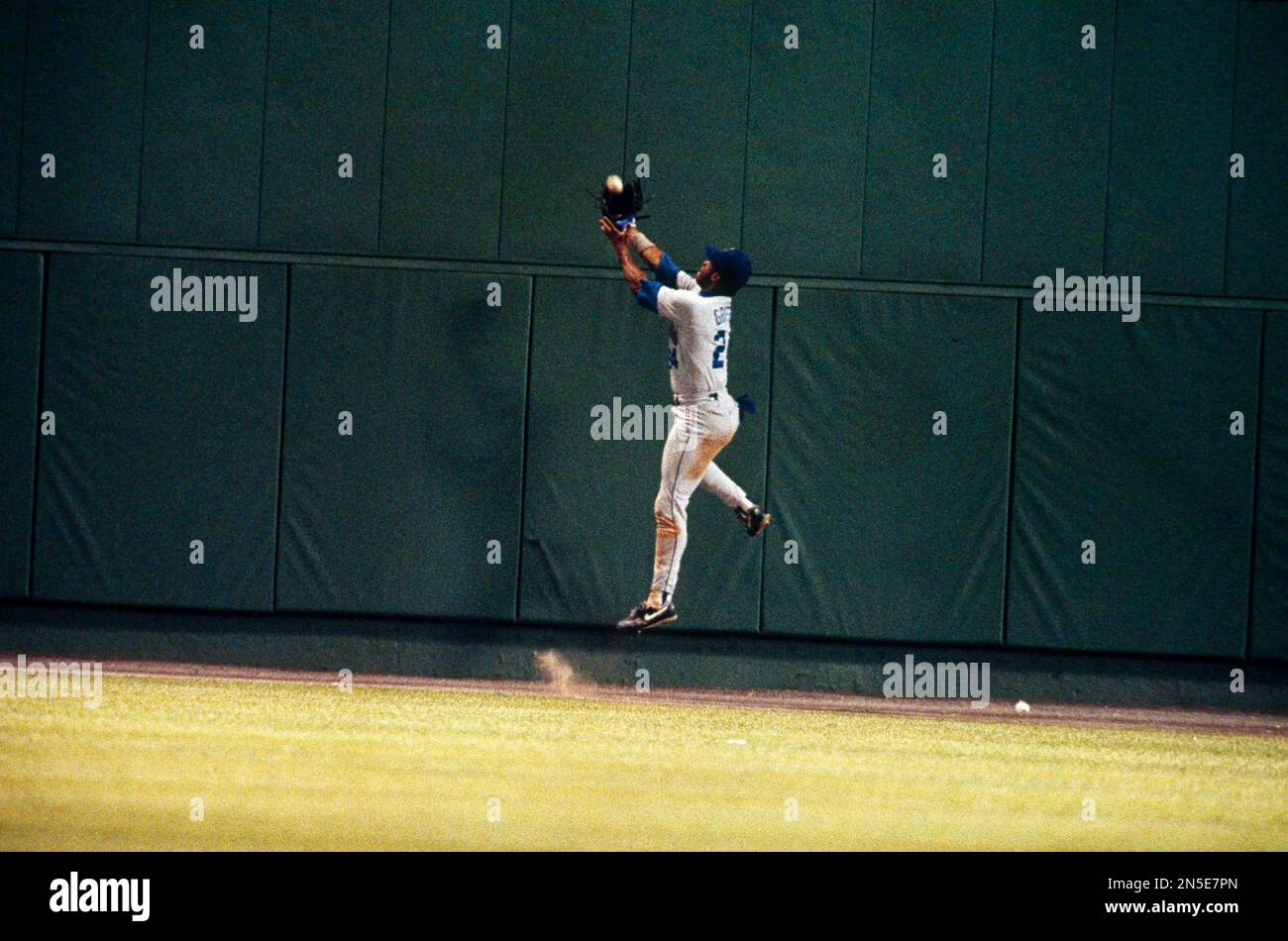 Ken Griffey Jr. of the Seattle Mariners leaps to make a catch on a long ...
