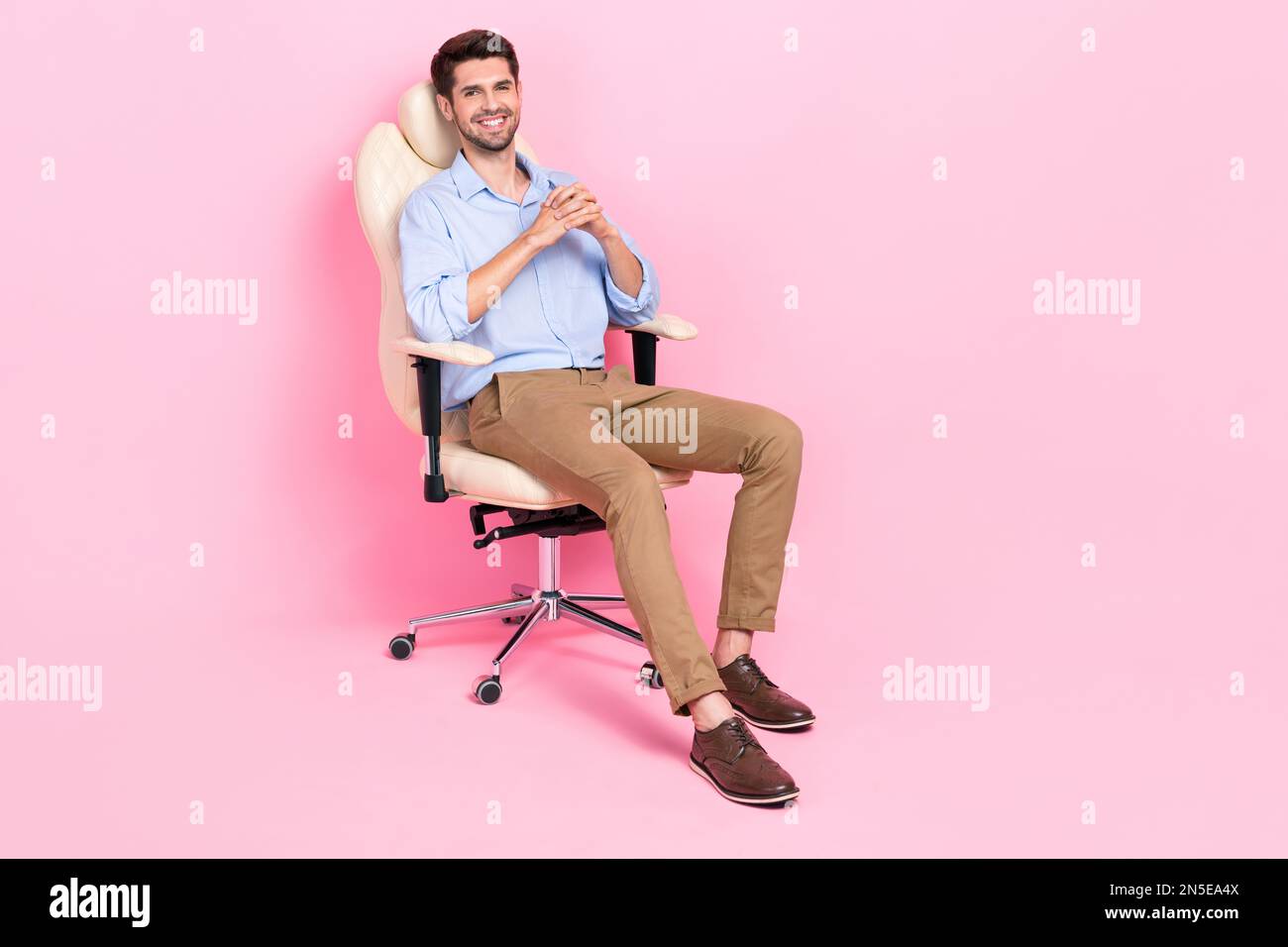 Full length photo of positive confident man sitting comfort chair relax ...