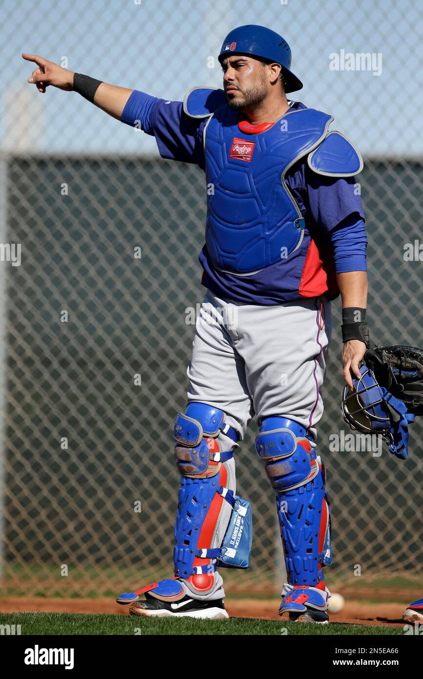 Texas Rangers catcher Geovany Soto gestures as he works out in the bull ...