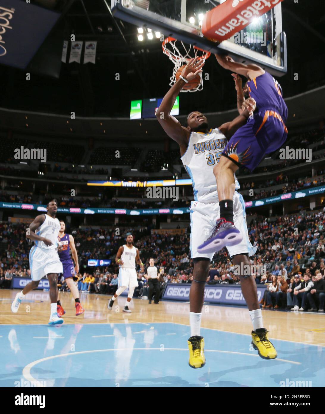 Phoenix Suns guard Gerald Green, right, flies over Denver Nuggets ...