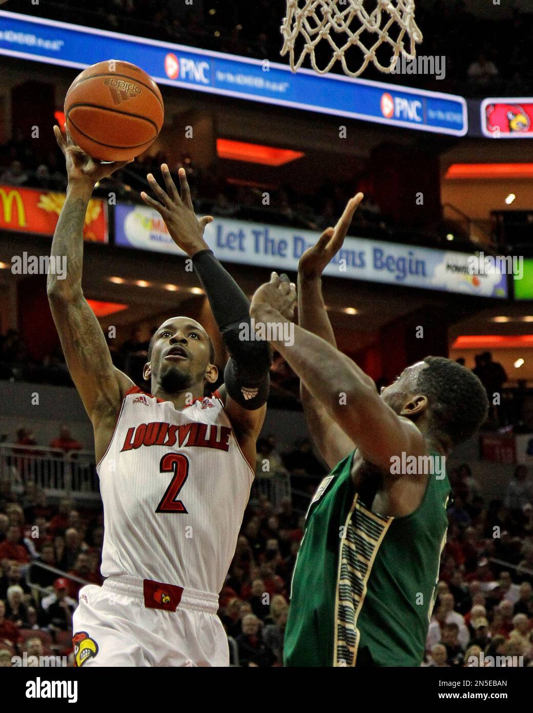 Louisville guard Russ Smith (2) launches a shot over South Florida ...