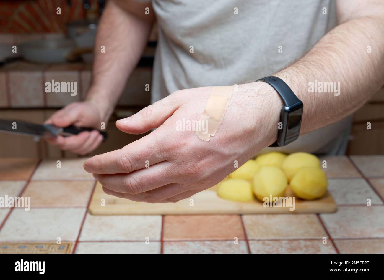 The chef cut his finger while cooking Stock Photo - Alamy