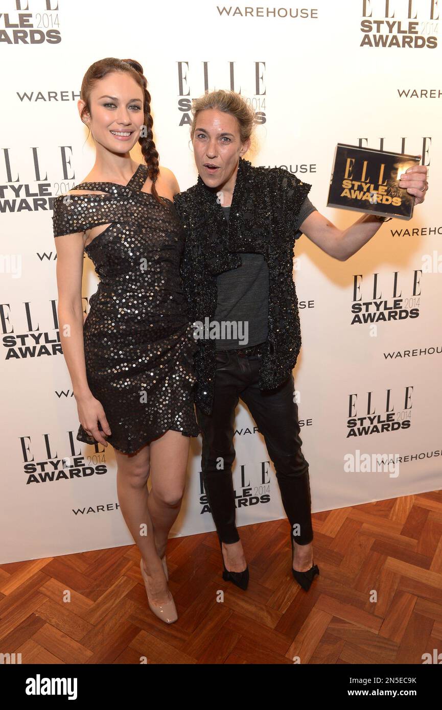 French actress and model Olga Kurylenko, left, presents French designer ...