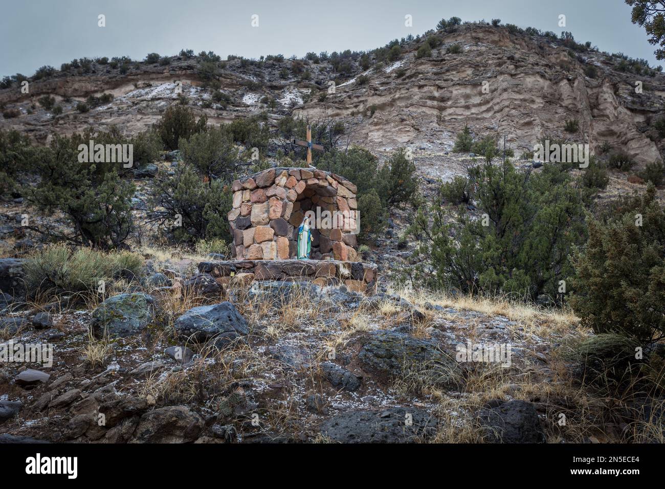 Religious memorial with Mother Mary in stone temple on side of mountian ...