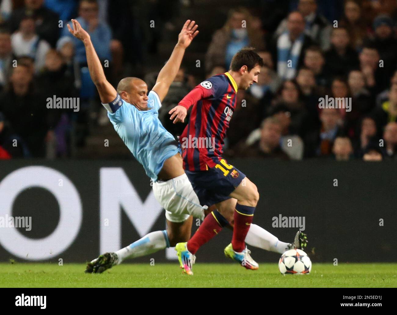 Manchester City's Vincent Kompany fights for the ball with Barcelona's ...