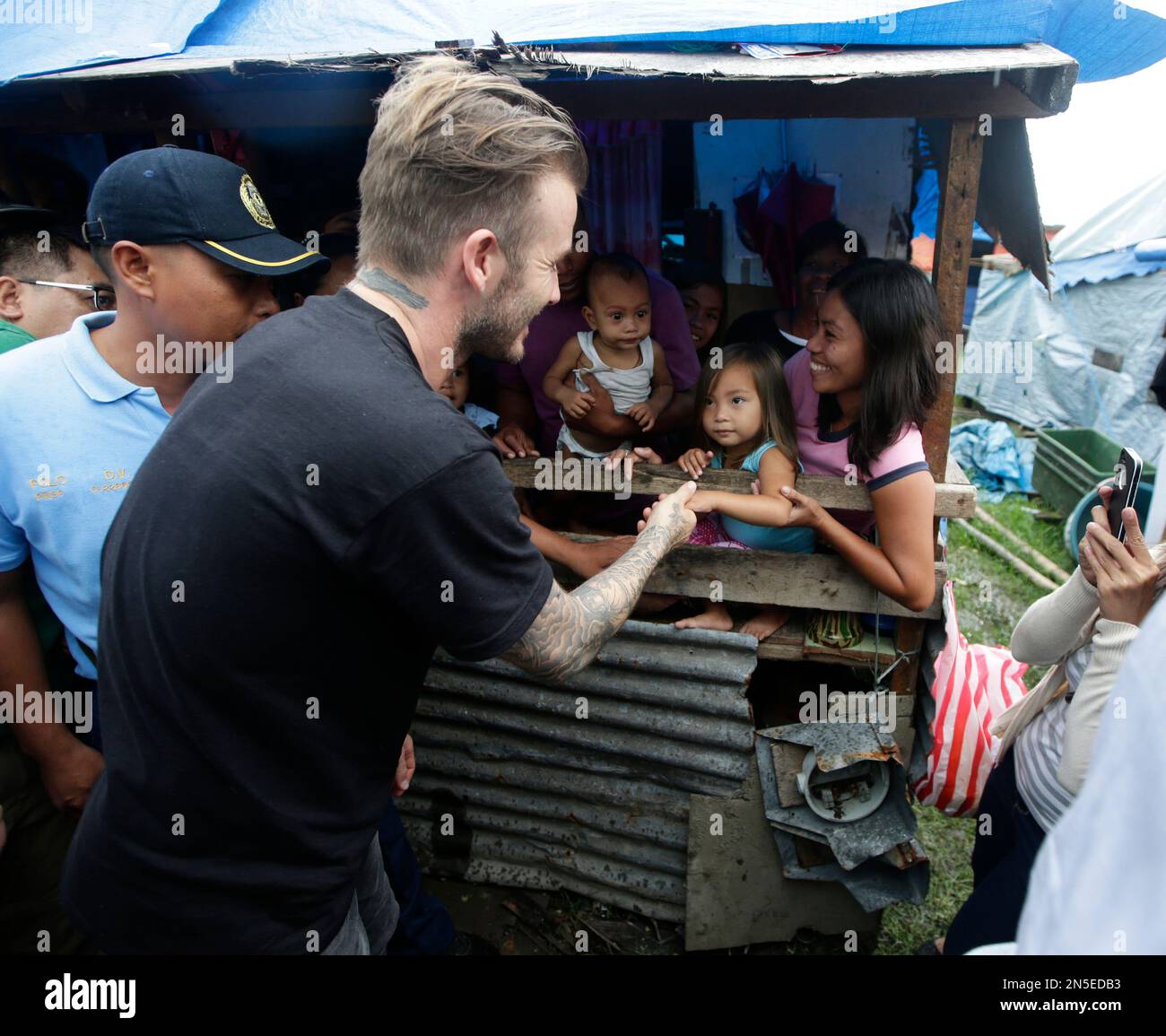 British soccer player David Beckham interacts with typhoon survivors ...
