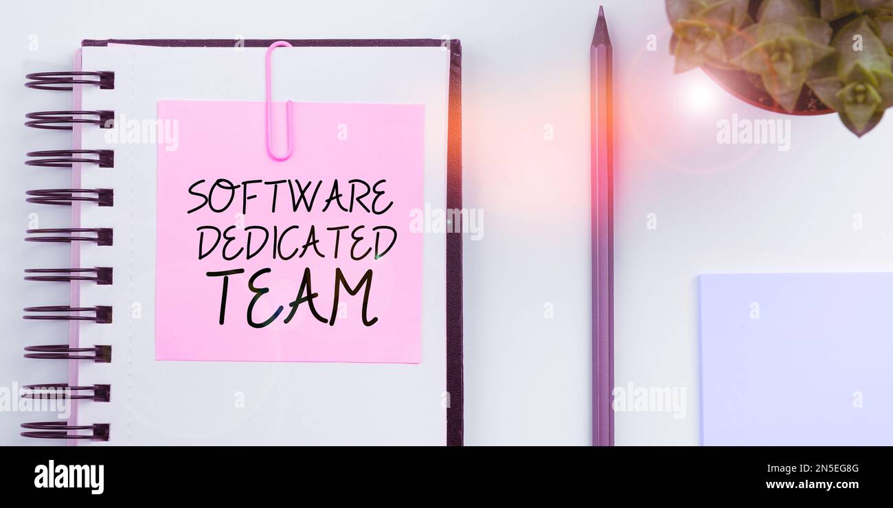 Hand writing sign Software Dedicated Team. Business showcase people ...