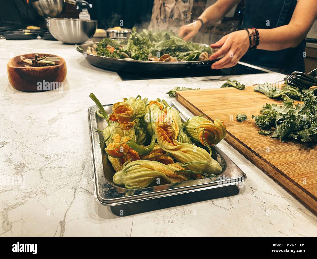 Process of making zucchini flowers. A white woman with bangles on her ...