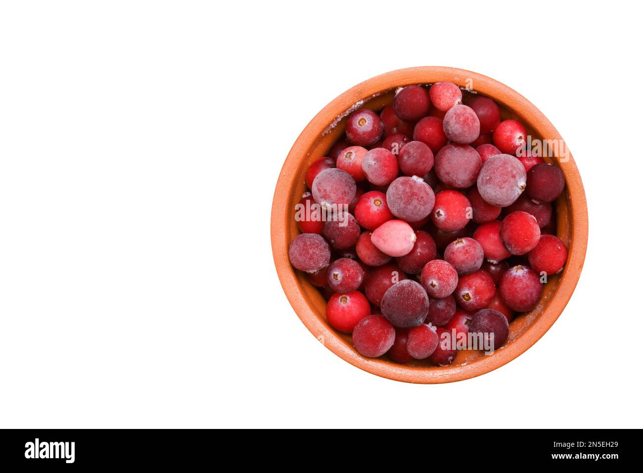 red berry cranberries in a clay pot isolated on white background Stock ...