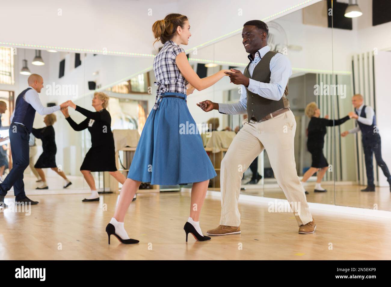 Woman with african man practising charleston dancing Stock Photo - Alamy