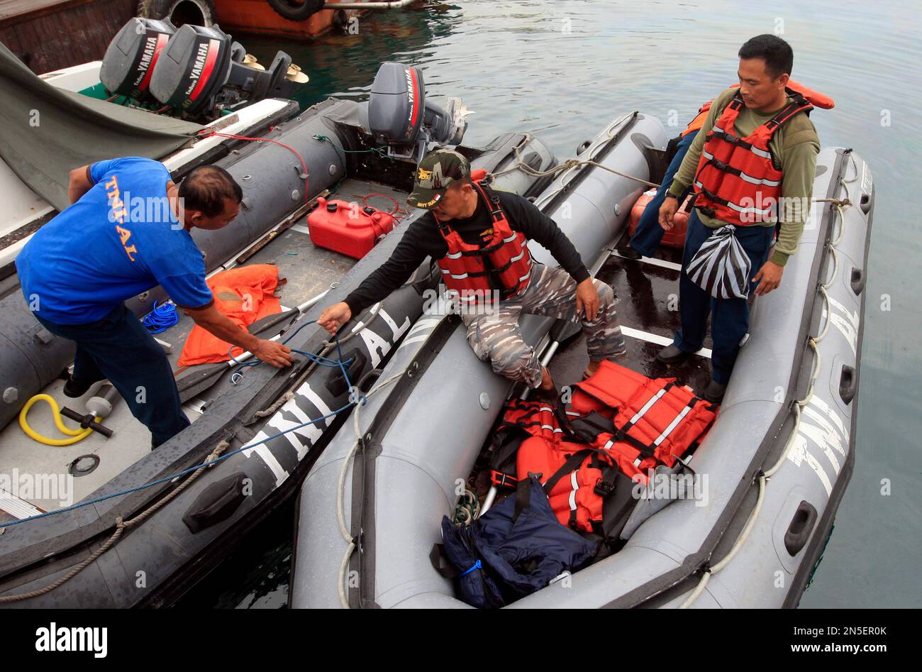 Indonesian navy rescue team members prepare their boat as they continue ...